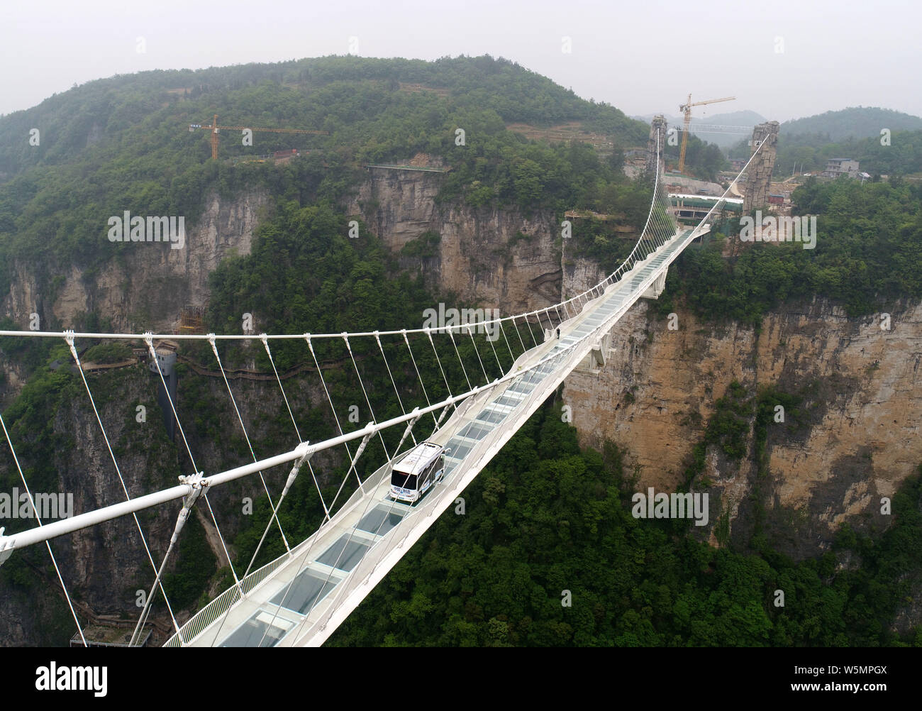 An unmanned bus drives on the world's longest and highest glass ...