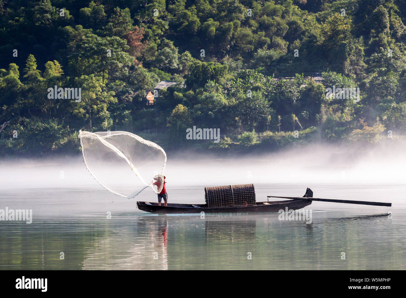 In this undated photo, a Chinese fisherman harvests fish along the ...
