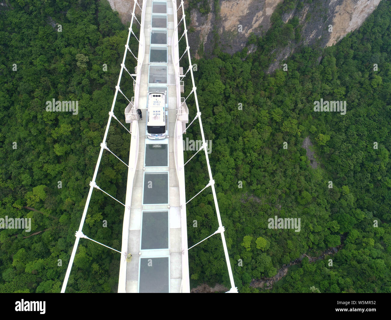 An unmanned bus drives on the world's longest and highest glass ...
