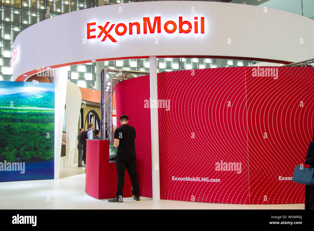 --FILE--People visit the stand of US-based ExxonMobil Corp during an ...