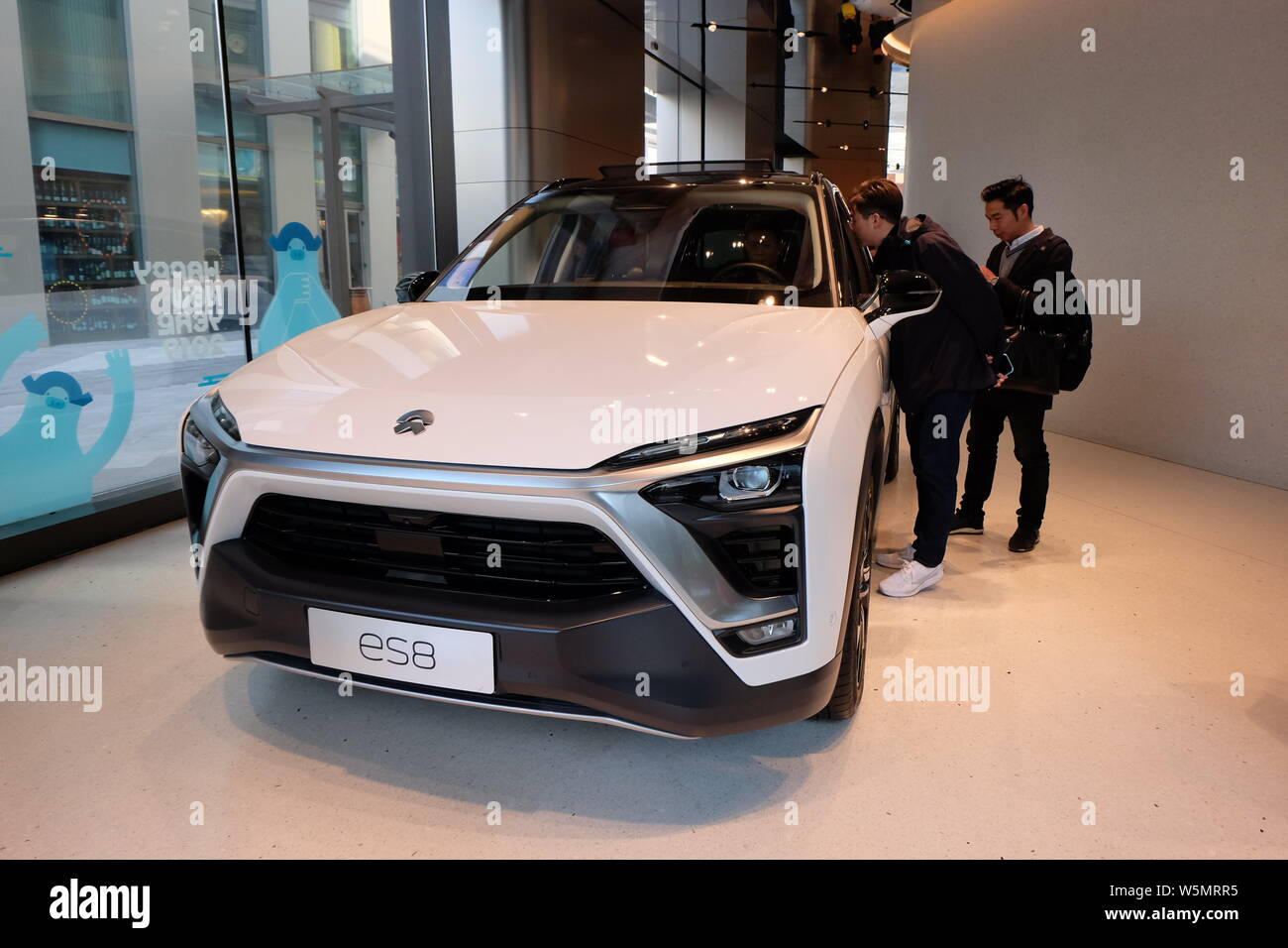 --FILE--Visitors view a NIO ES8 electric SUV of NextEV is on display at ...
