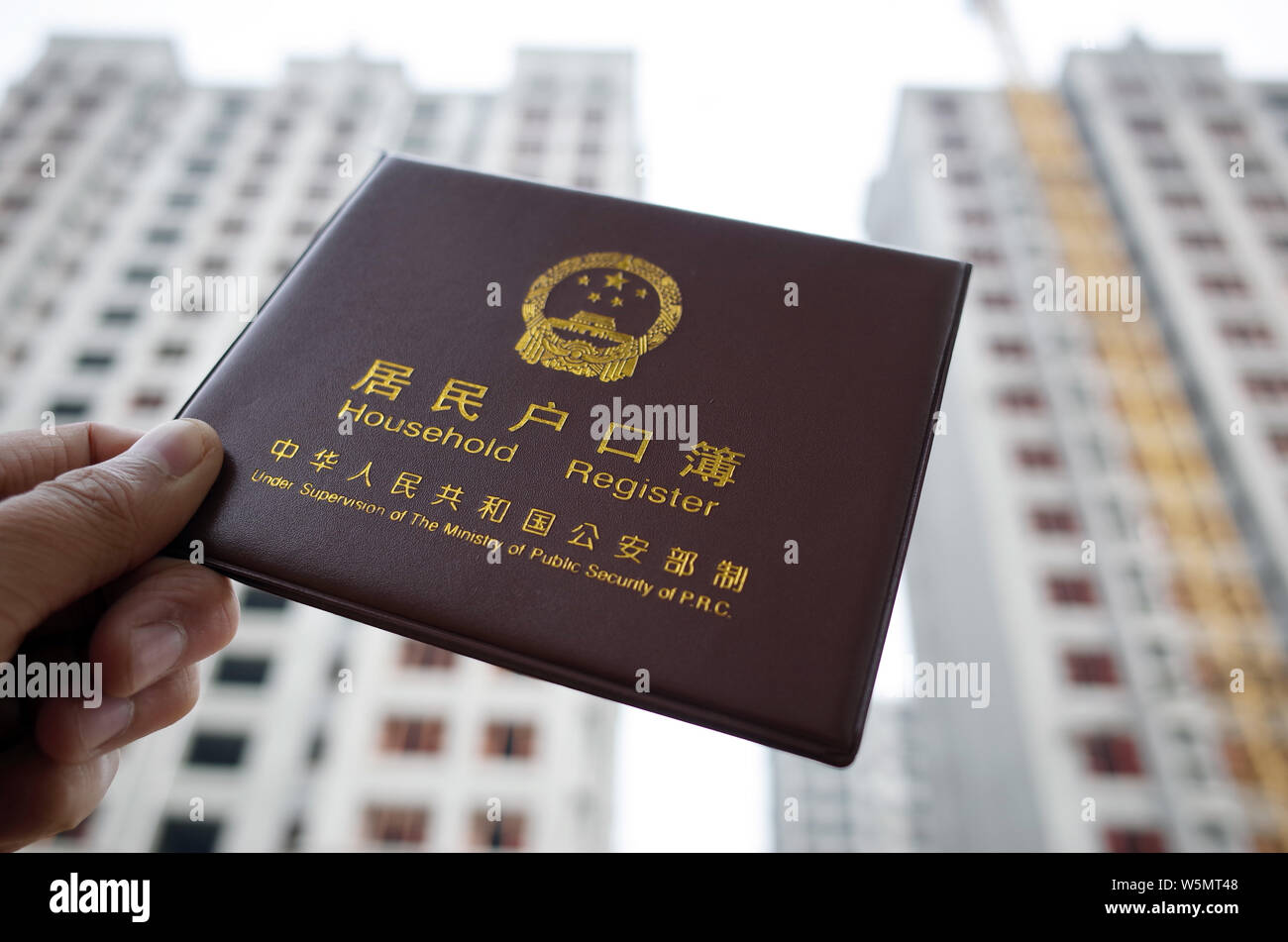 --FILE--A local Chinese resident shows his household register, also ...
