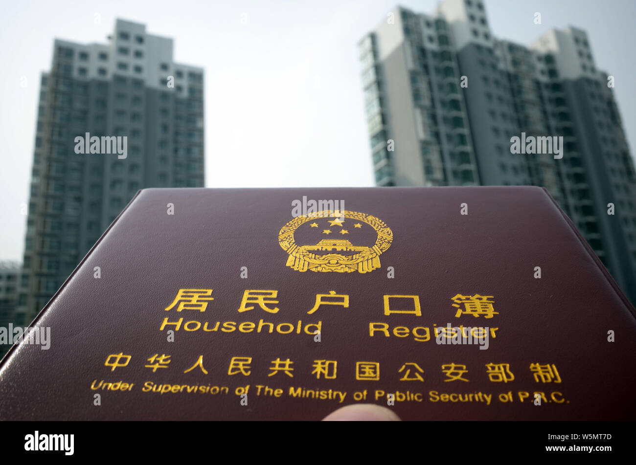 --FILE--A local Chinese resident shows his household register, also ...
