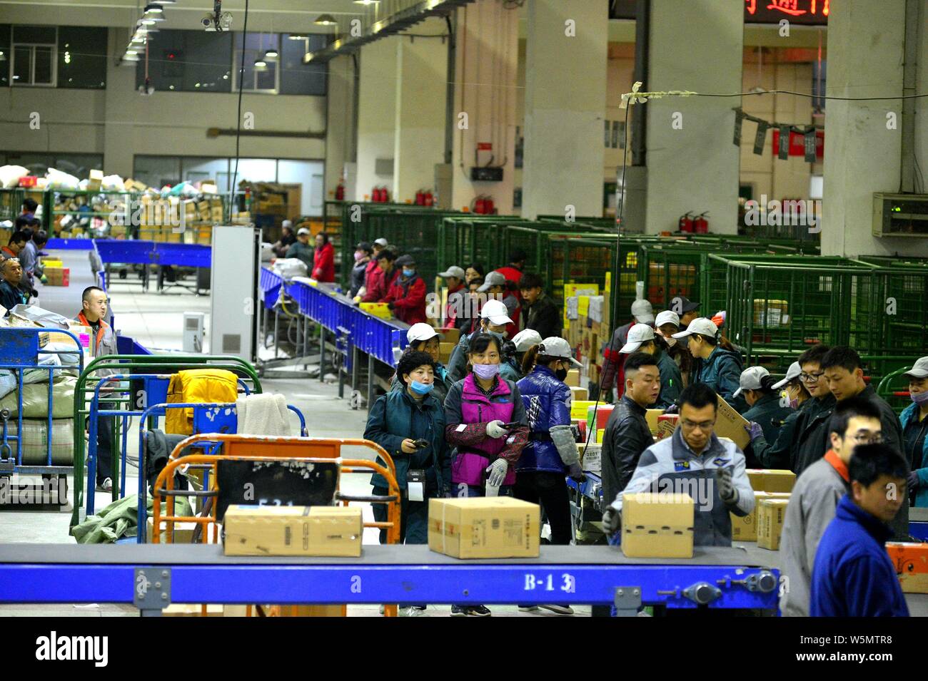 --FILE--Chinese workers sort out parcels, most of which are from Singles' Day online shopping ...
