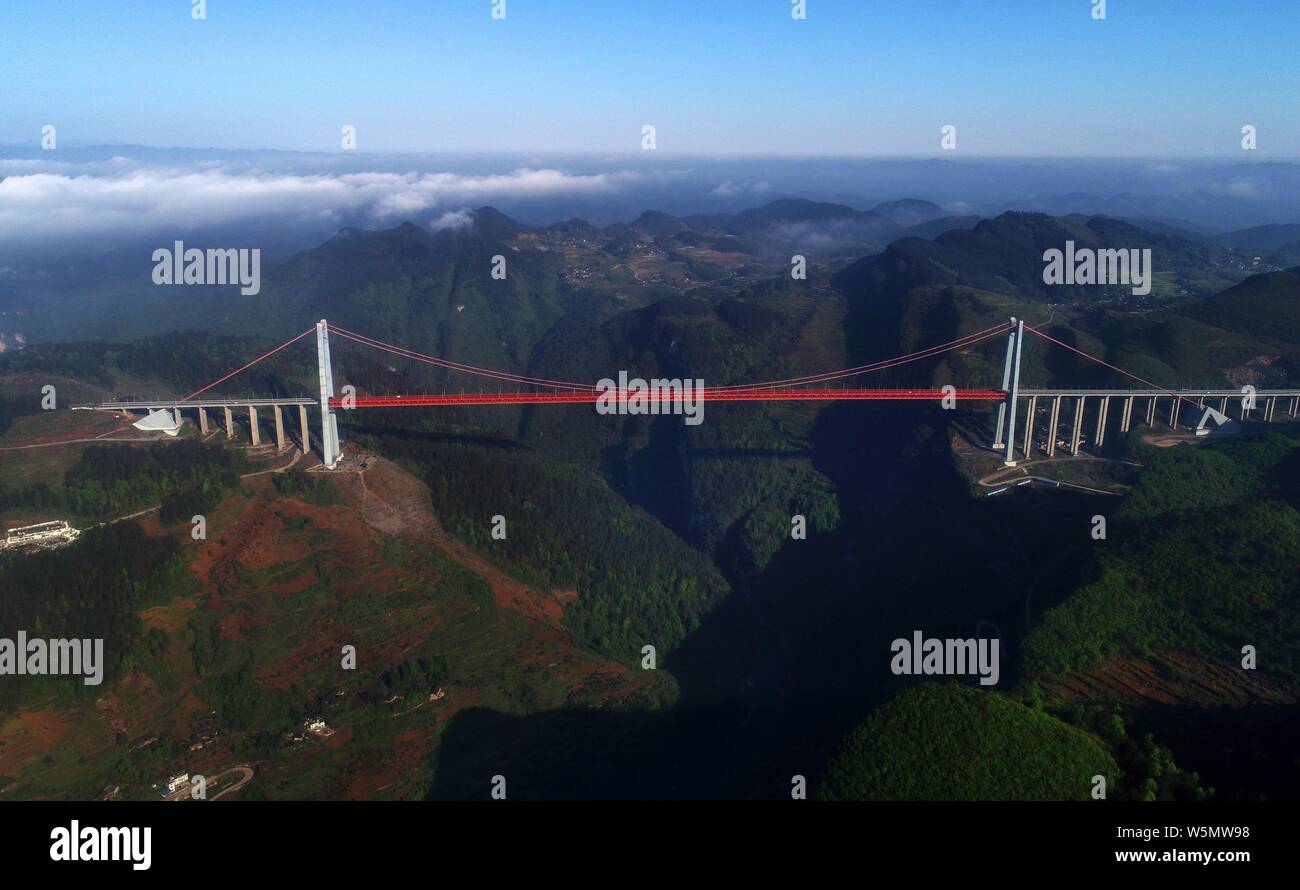 Cars drive on the Qingshui River Bridge, which is third highest ...
