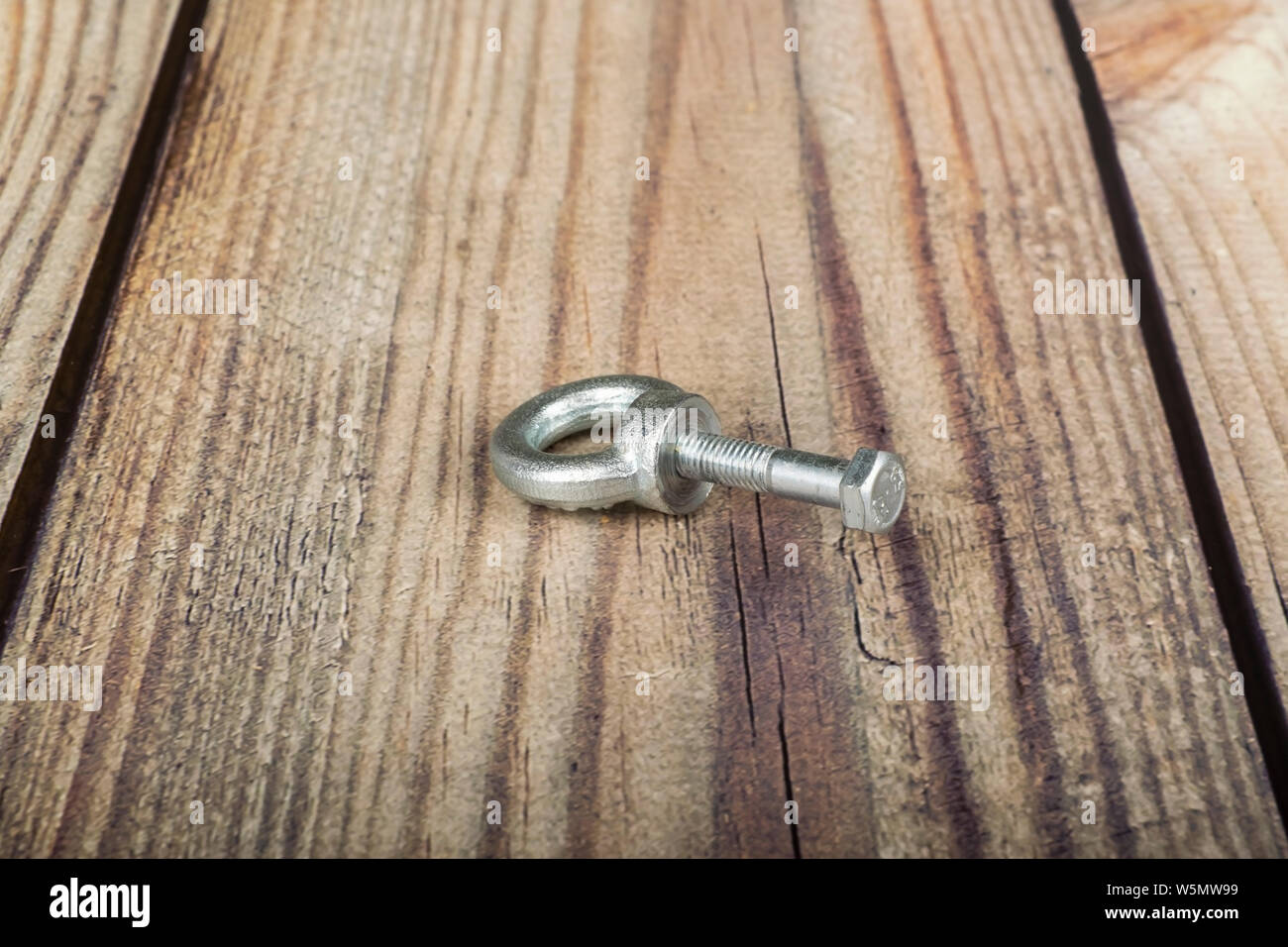 ring nut with bolt, zinc plated on wooden background Stock Photo - Alamy