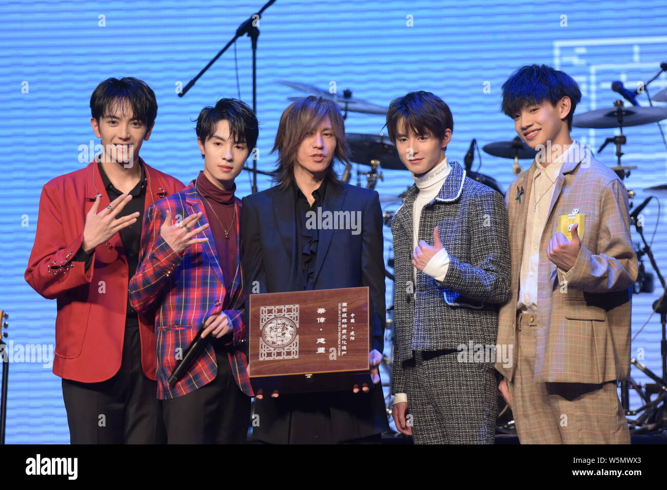 Japanese musician Yune Sugihara, center, better known by his stage name ...