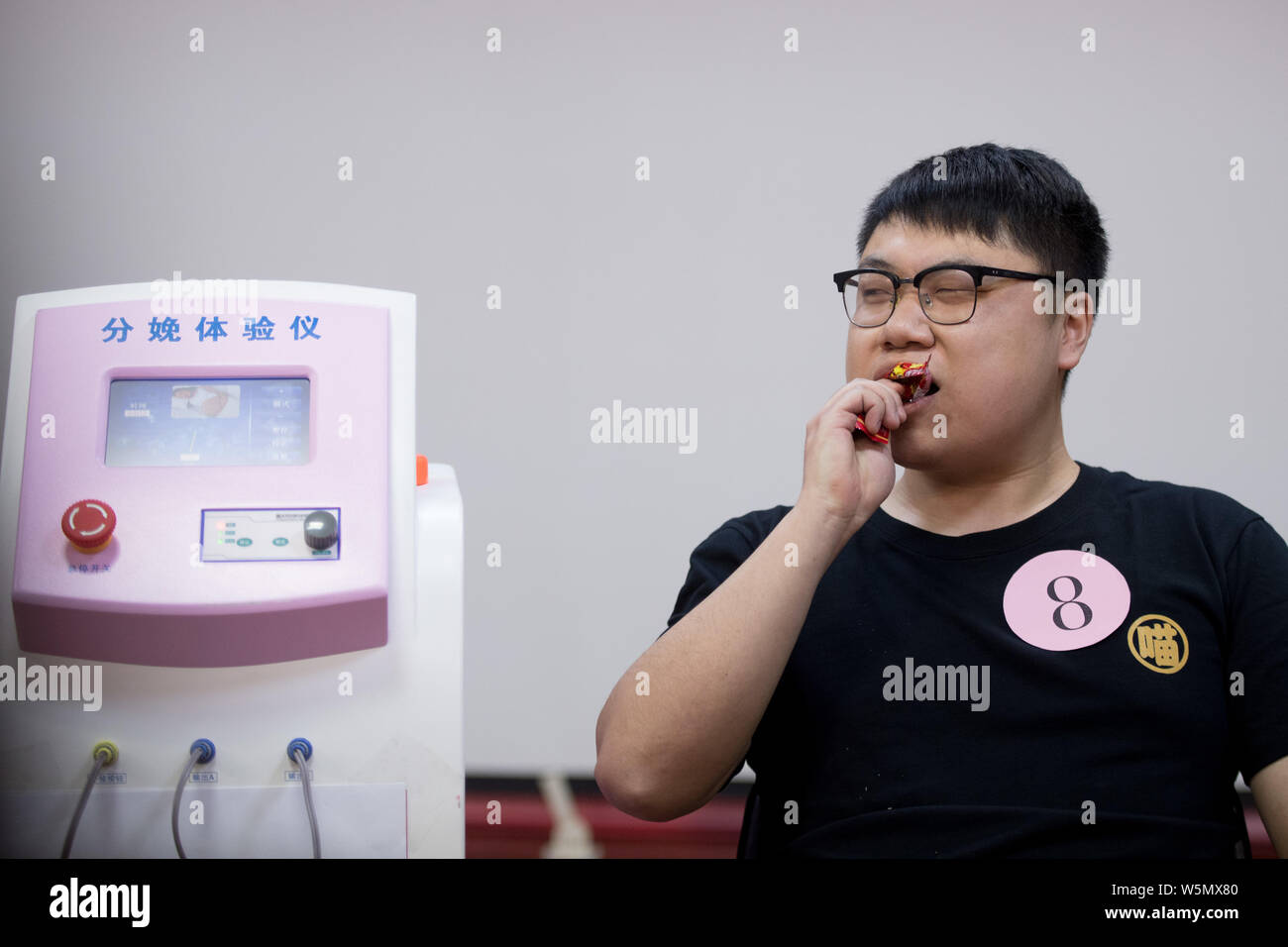 The face of an expectant father contorts as he experiences the pain of ...