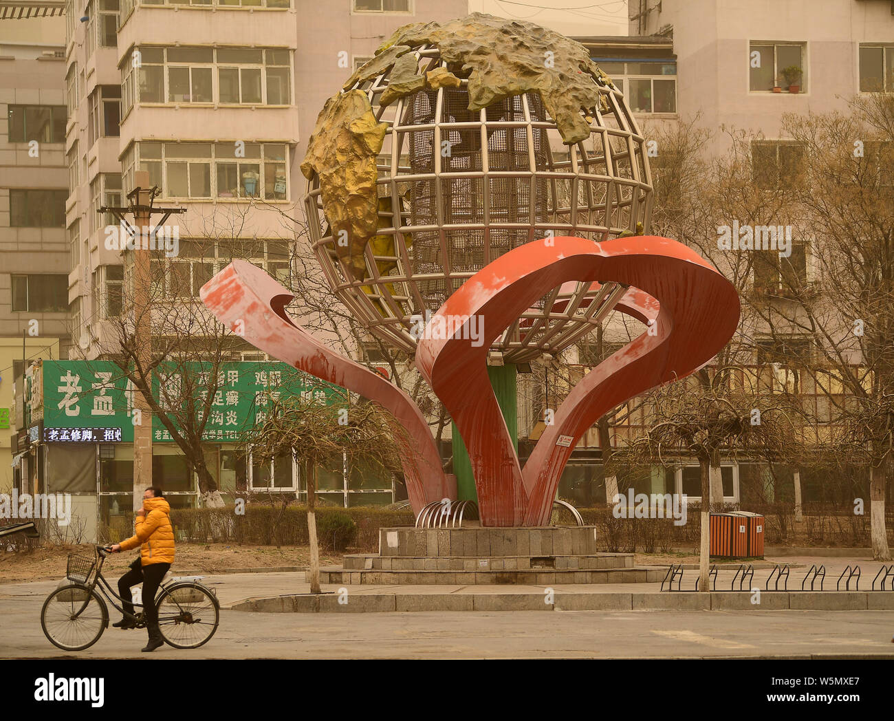 Cyclists cover their mouths against air pollution as they ride on a ...