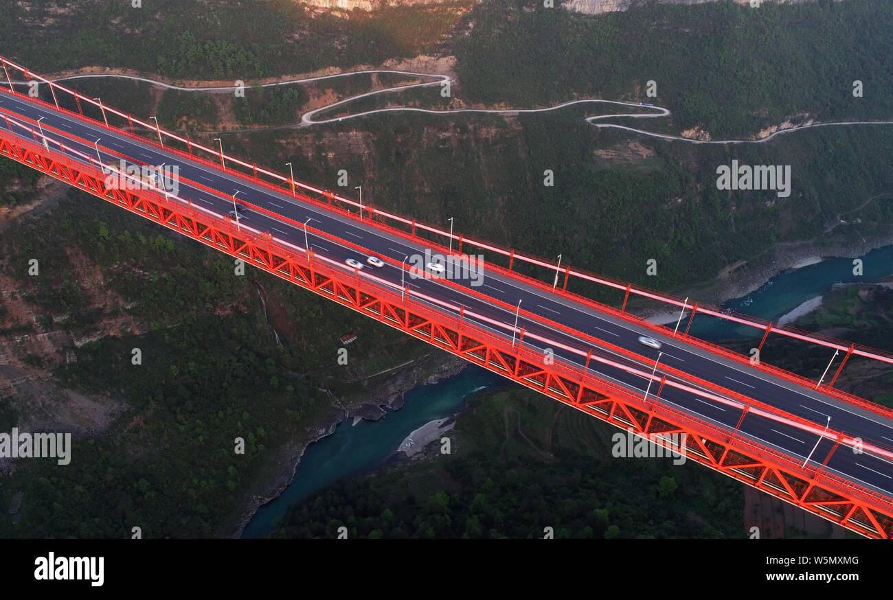 Cars drive on the Qingshui River Bridge, which is third highest ...