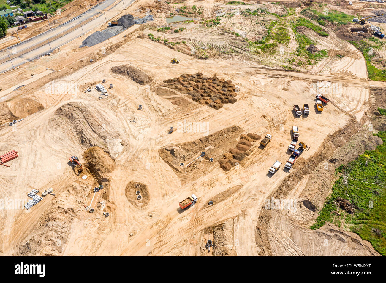 aerial top view of construction site with excavator and dump trucks ...
