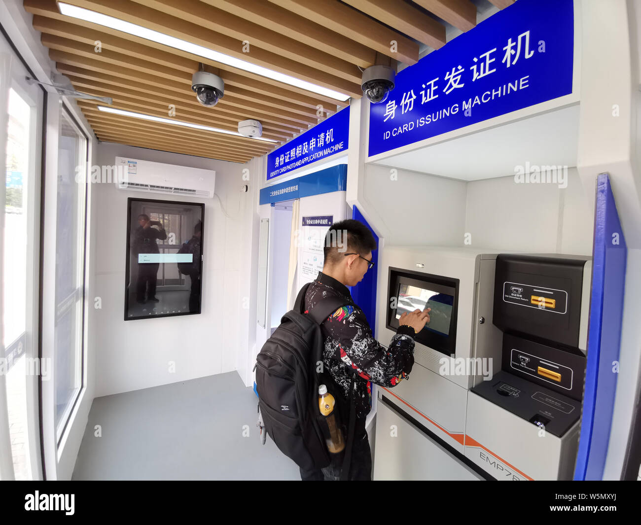 A local resident uses the ID card issuing machine at a self-service ...