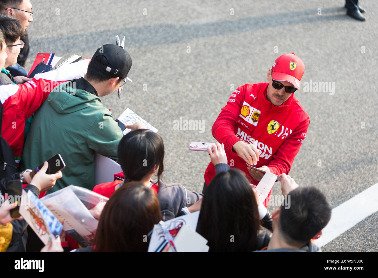German racing driver Sebastian Vettel of Scuderia Ferrari signs ...