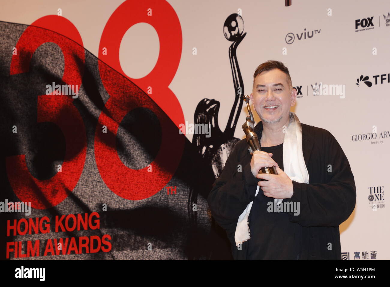 Hong Kong actor Anthony Wong poses with his trophy after winning "Best ...