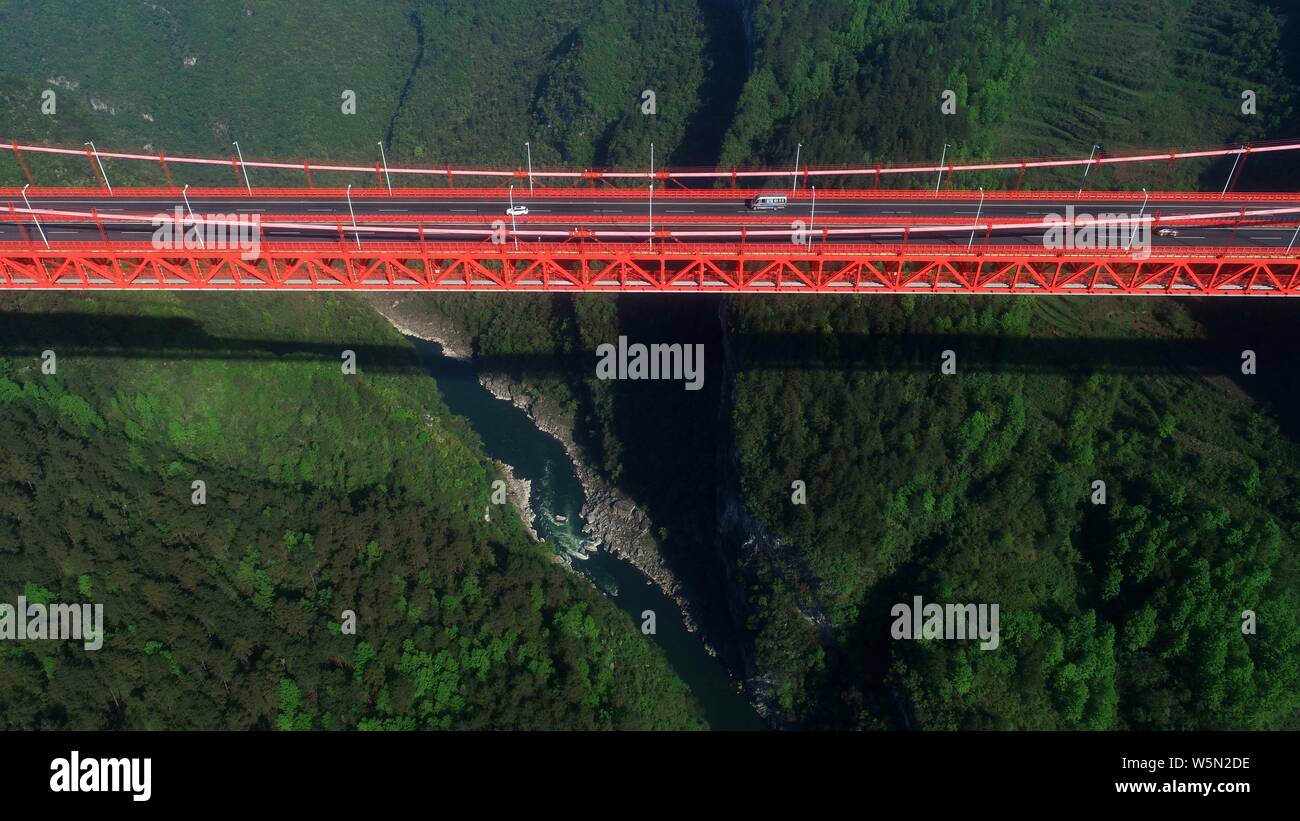 Cars drive on the Qingshui River Bridge, which is third highest ...