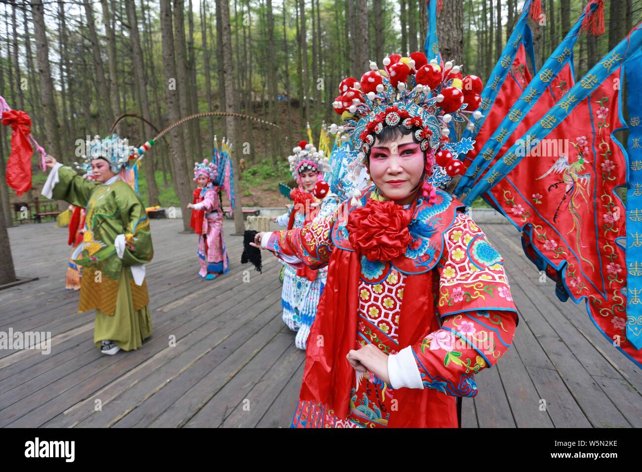 Chinese Yu Opera artists dressed in traditional costumes perform during ...