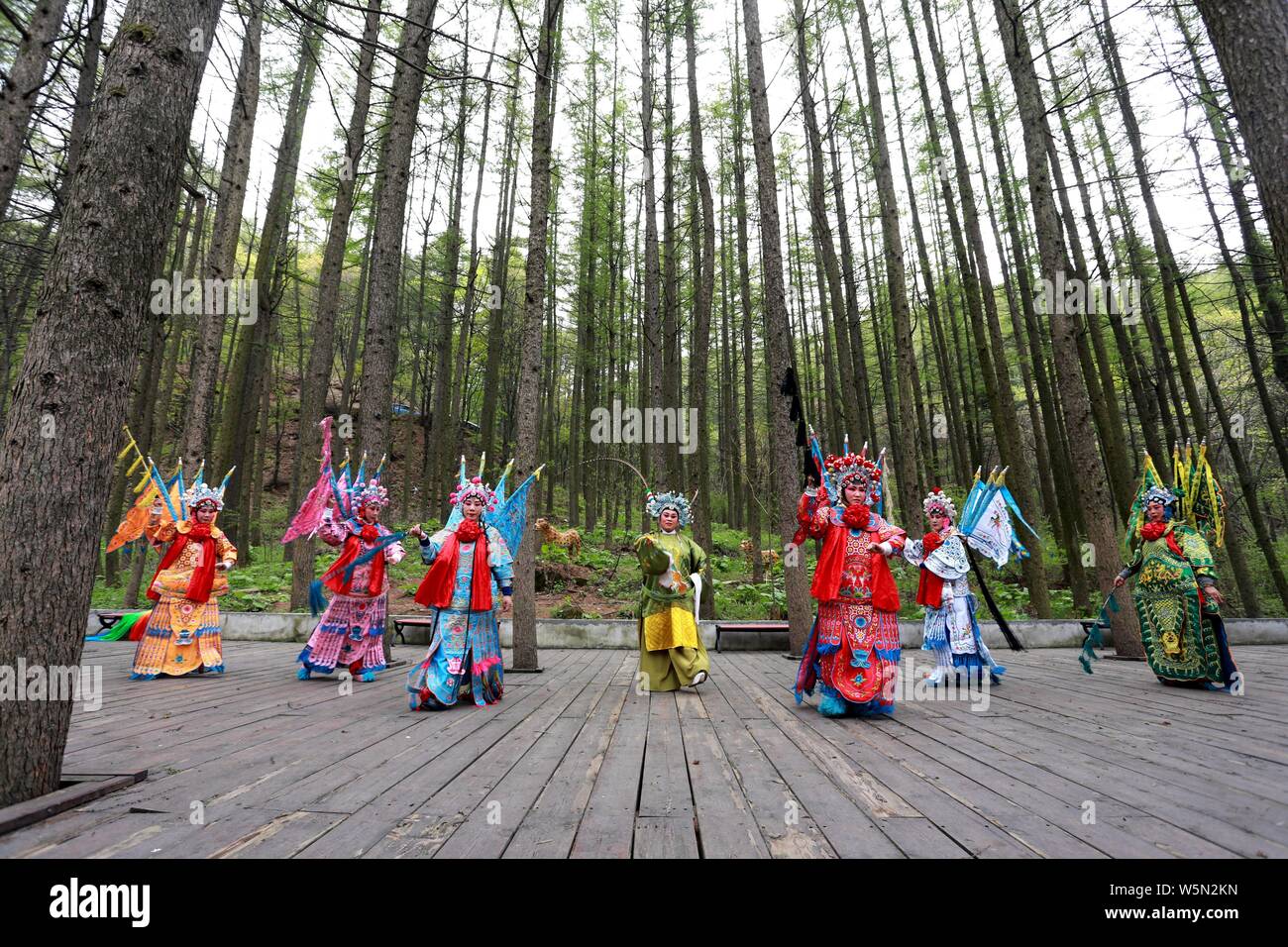 Chinese Yu Opera artists dressed in traditional costumes perform during ...