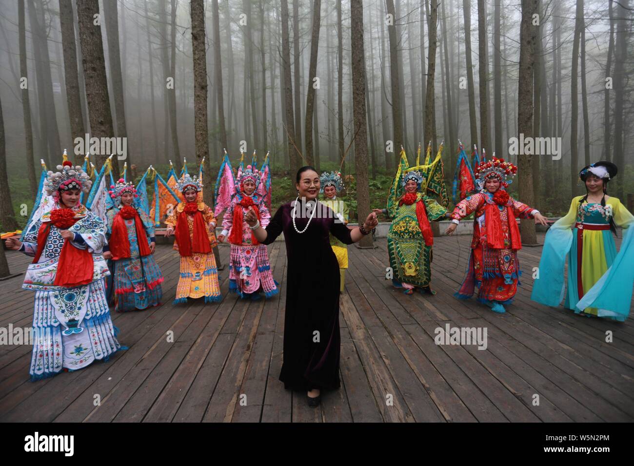 Chinese Yu Opera artists dressed in traditional costumes perform during ...