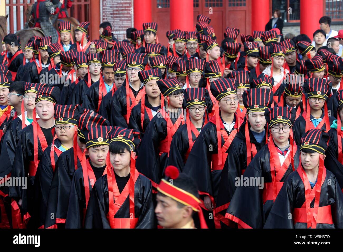 Students dressed in ancient Chinese costumes attend a traditional ...