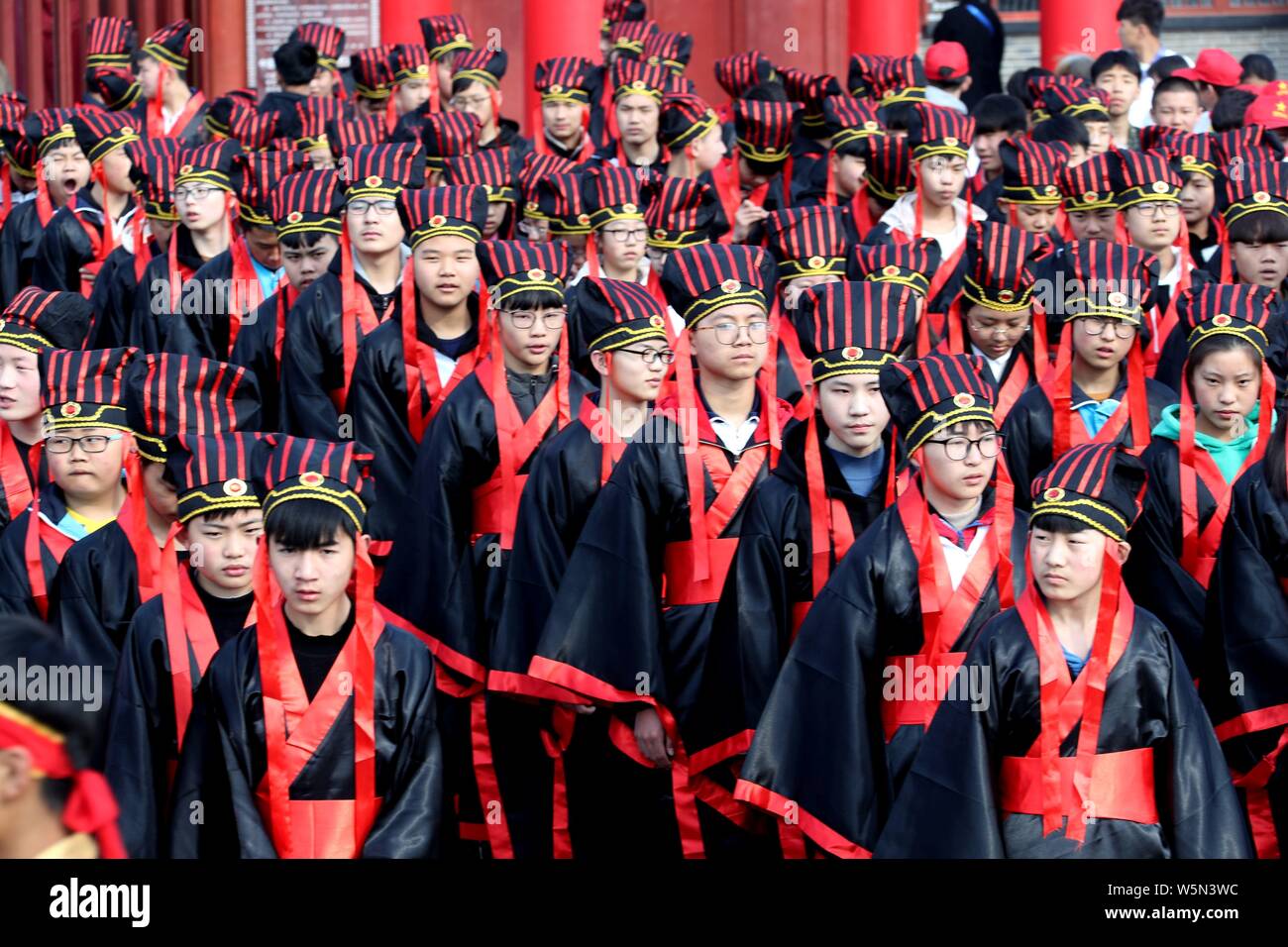 Students dressed in ancient Chinese costumes attend a traditional ...