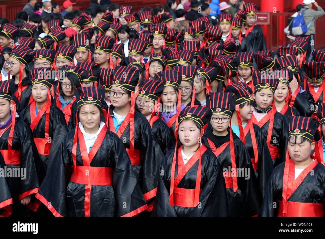 Students dressed in ancient Chinese costumes attend a traditional ...