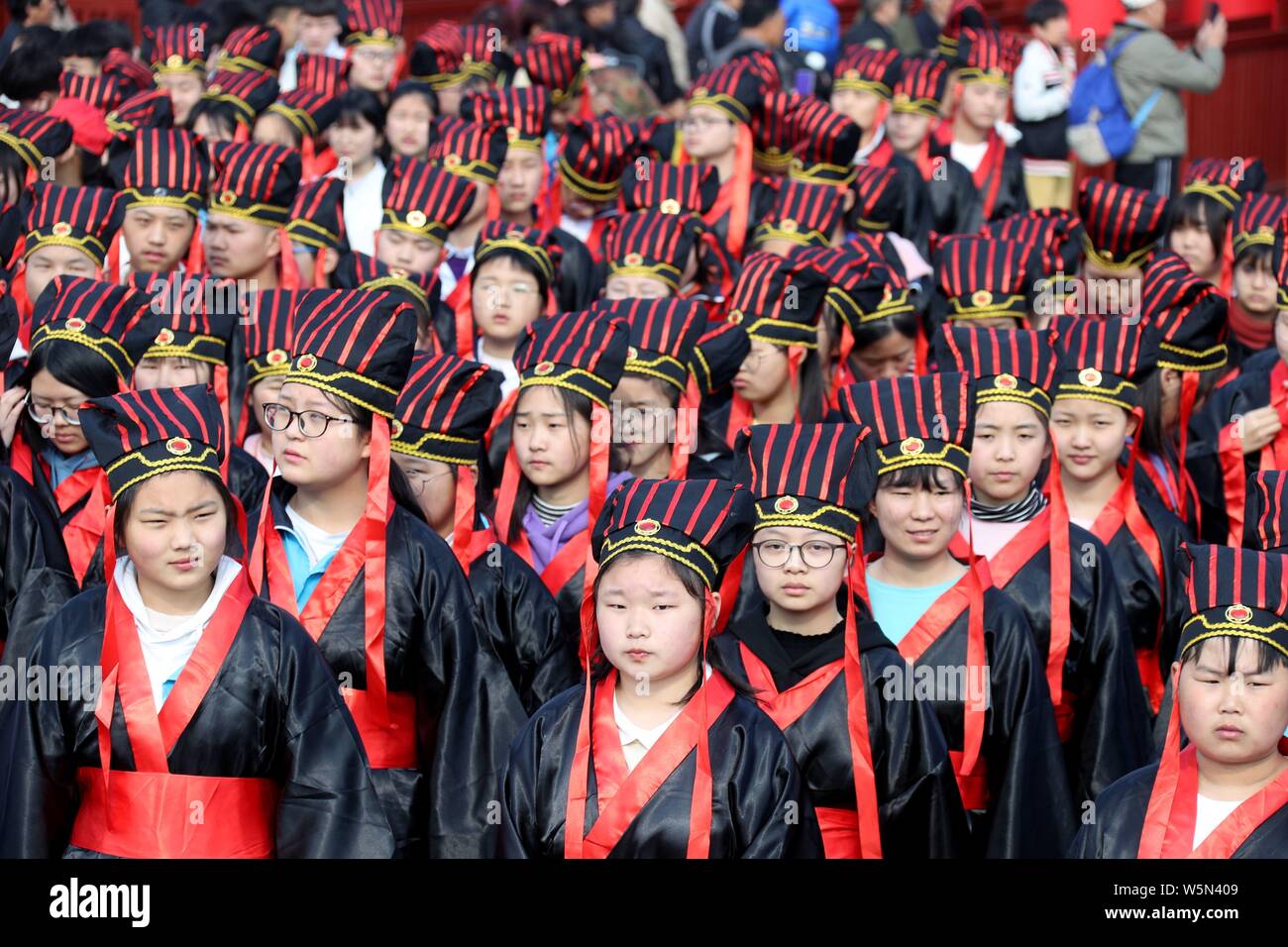 Students dressed in ancient Chinese costumes attend a traditional ...