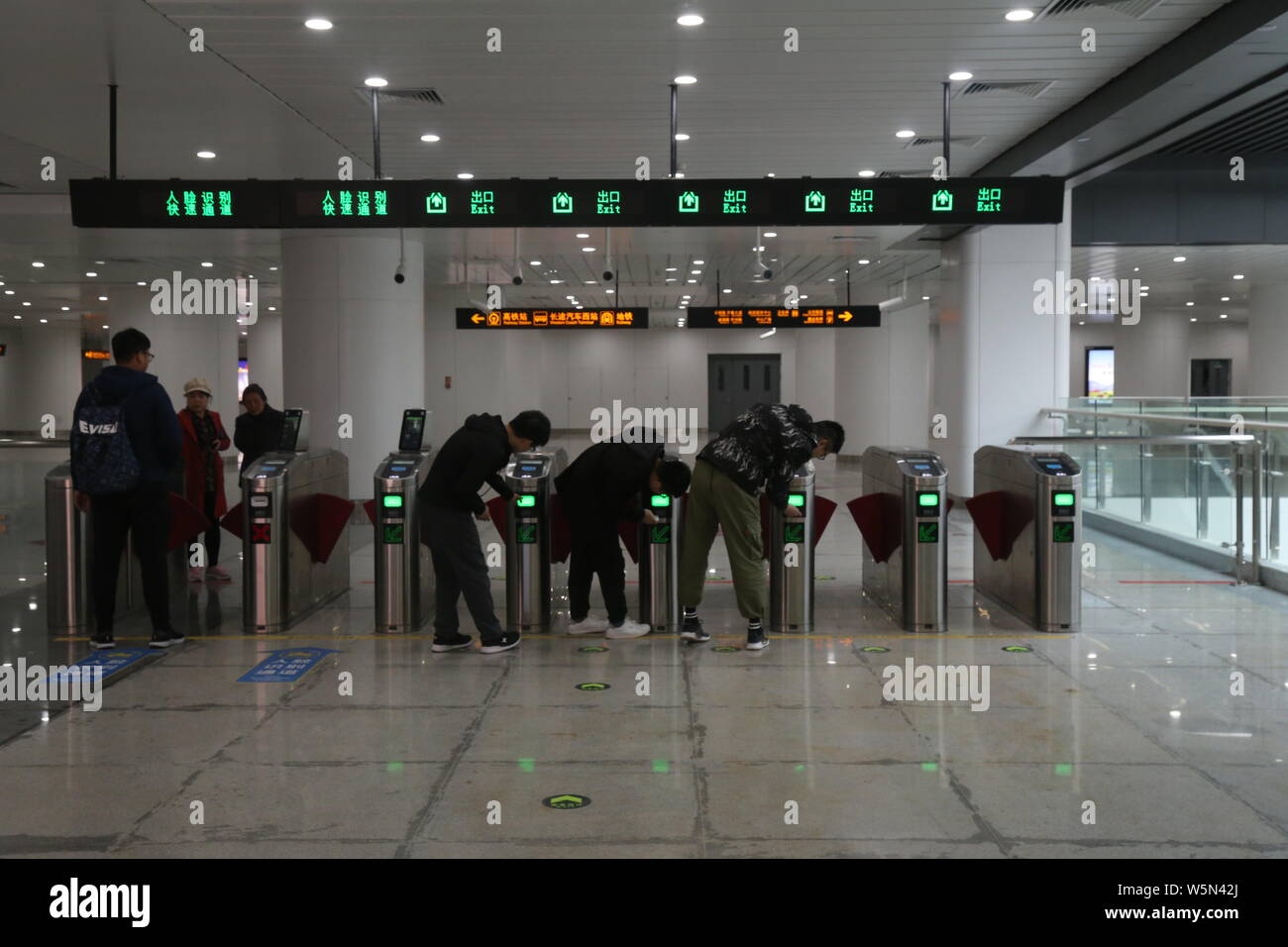 Passengers have their train tickets automatically scanned for check-in ...