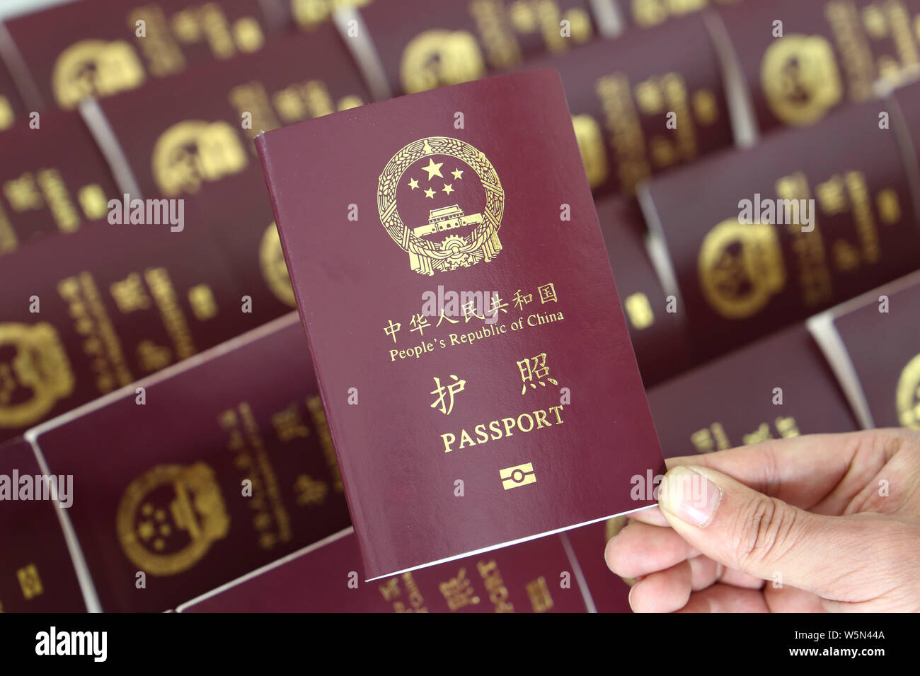 A Chinese policeman shows passports at a branch of local exit and entry ...