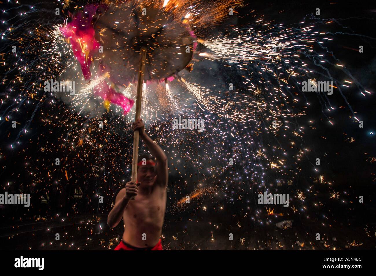 Chinese villagers push the paper tiger and flames were splashed high ...