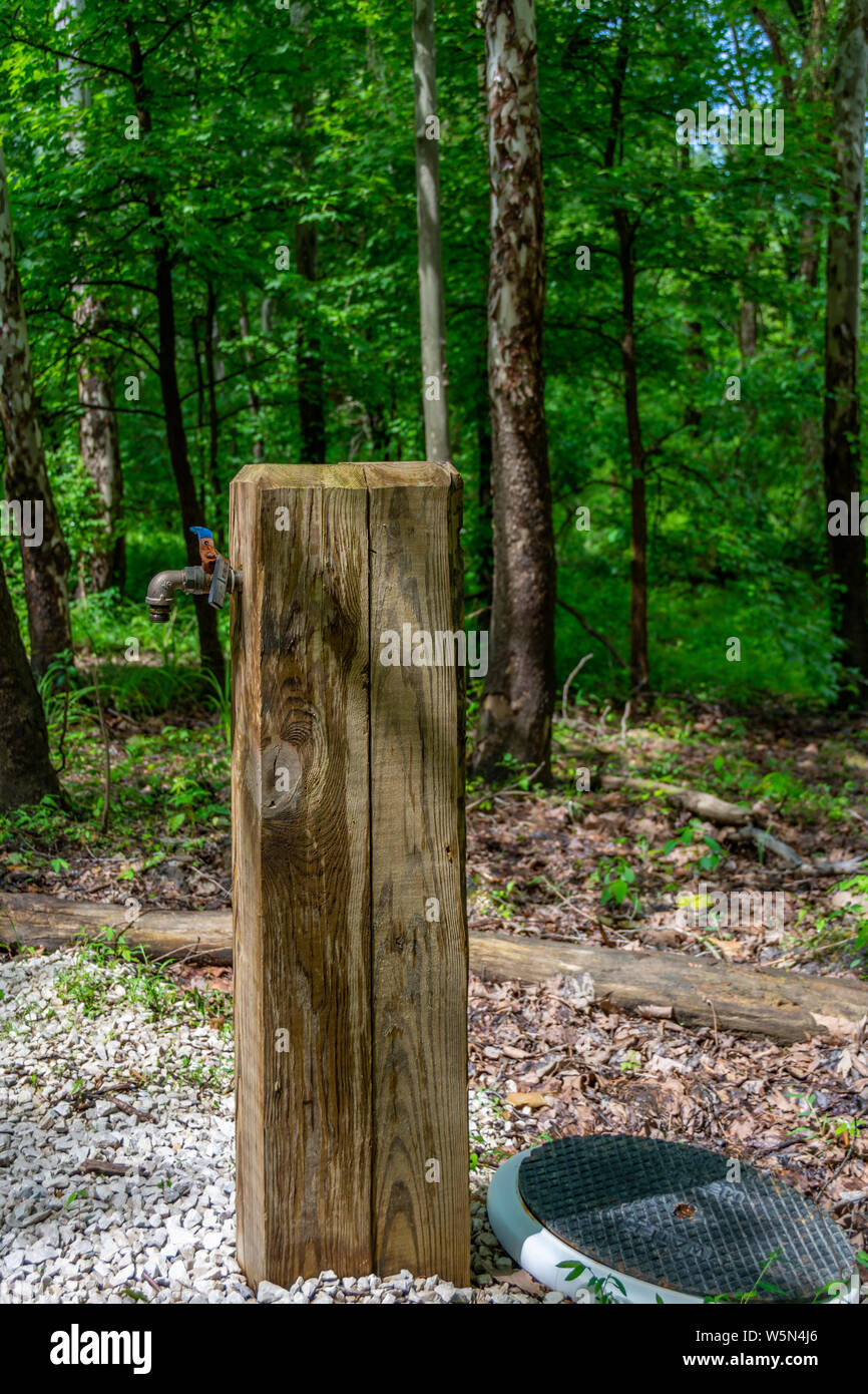 Water faucet hookup on a post for campers at a park recreation area ...