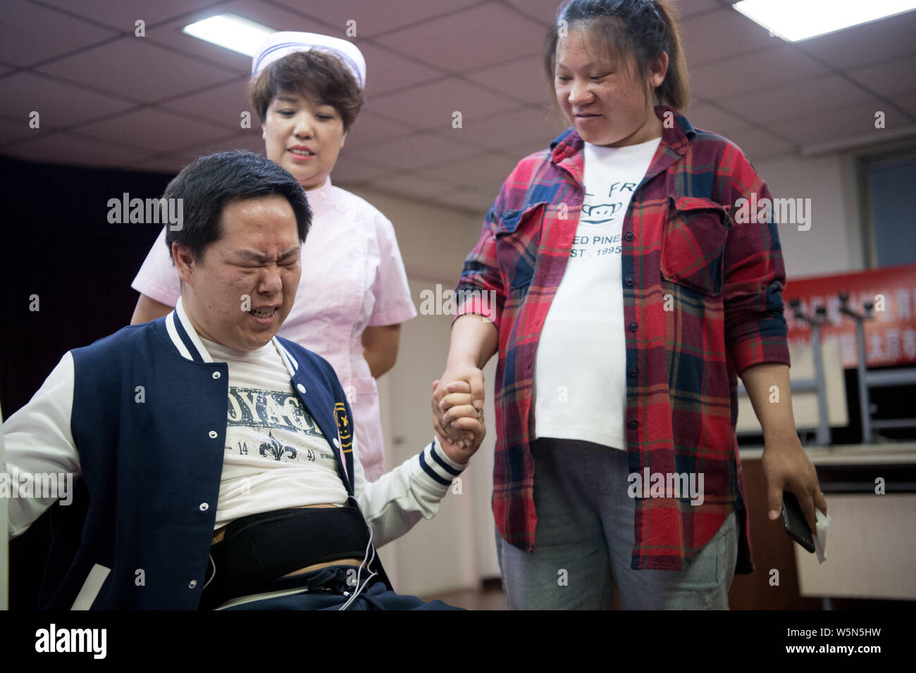 The face of an expectant father contorts as he experiences the pain of ...