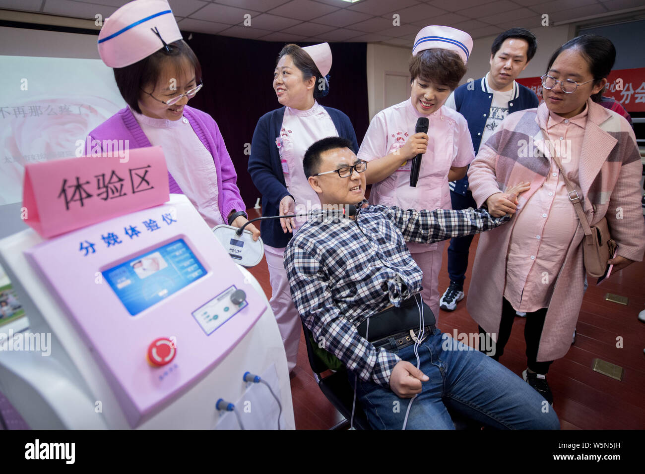 The face of an expectant father contorts as he experiences the pain of ...