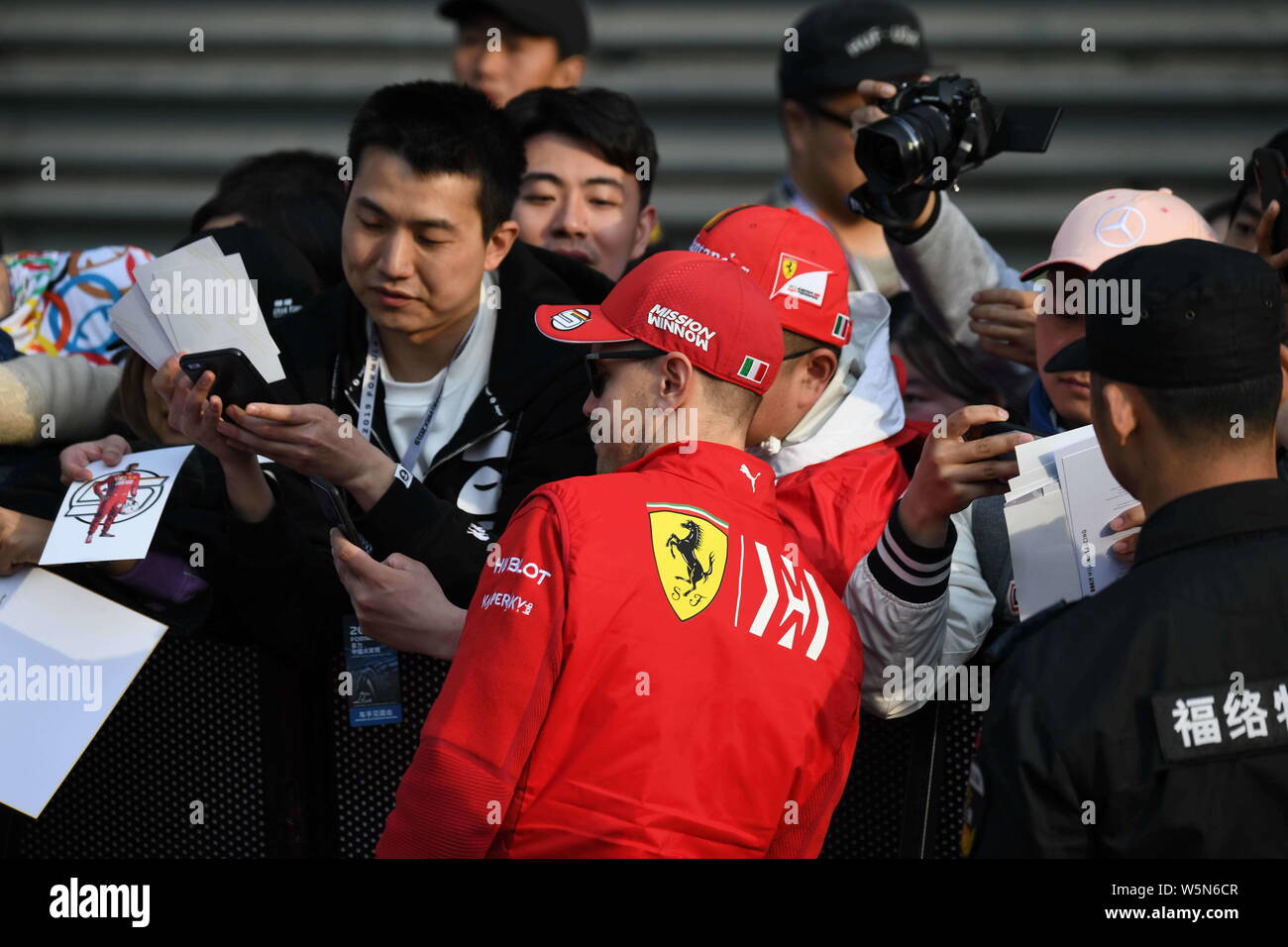 German racing driver Sebastian Vettel of Scuderia Ferrari signs ...