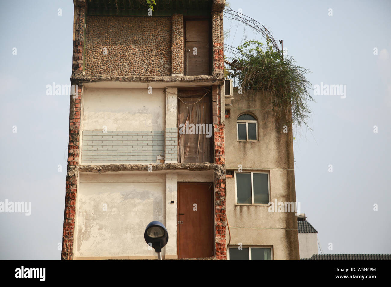 The half-demolished nine-floor residential building is pictured in ...