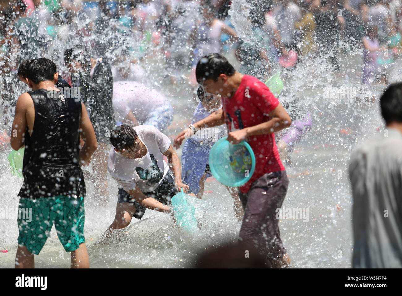 Tourists sprinkle water to each other to celebrate the Water-Splashing ...