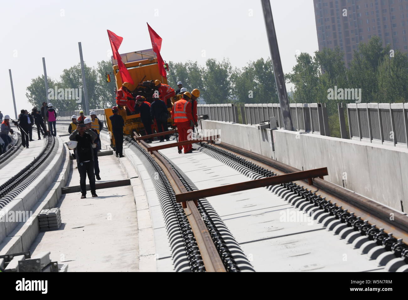 Chinese workers lay the tracks for the Beijing section of the Beijing ...