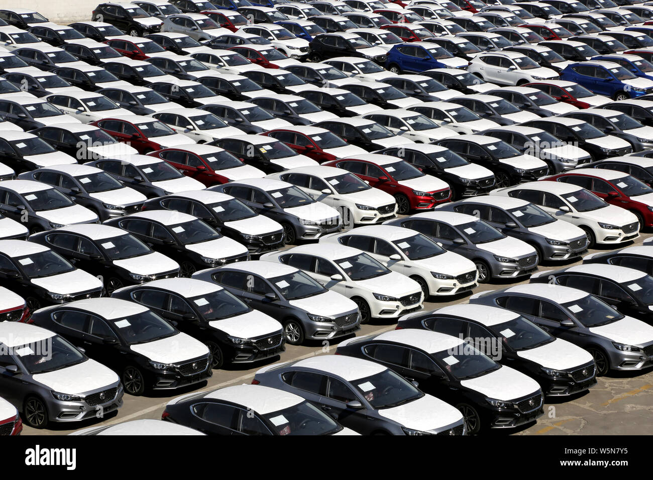 Aerial view of cars waiting to be exported aboard at a port in ...