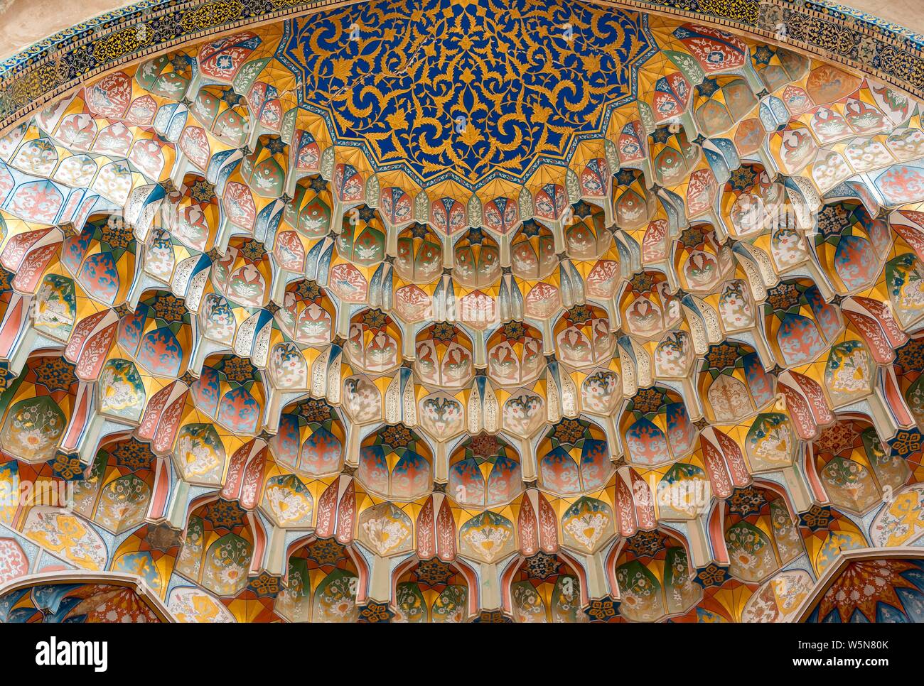 Decorative muqarnas vaulting in the iwan entrance of Abdulaziz Khan ...