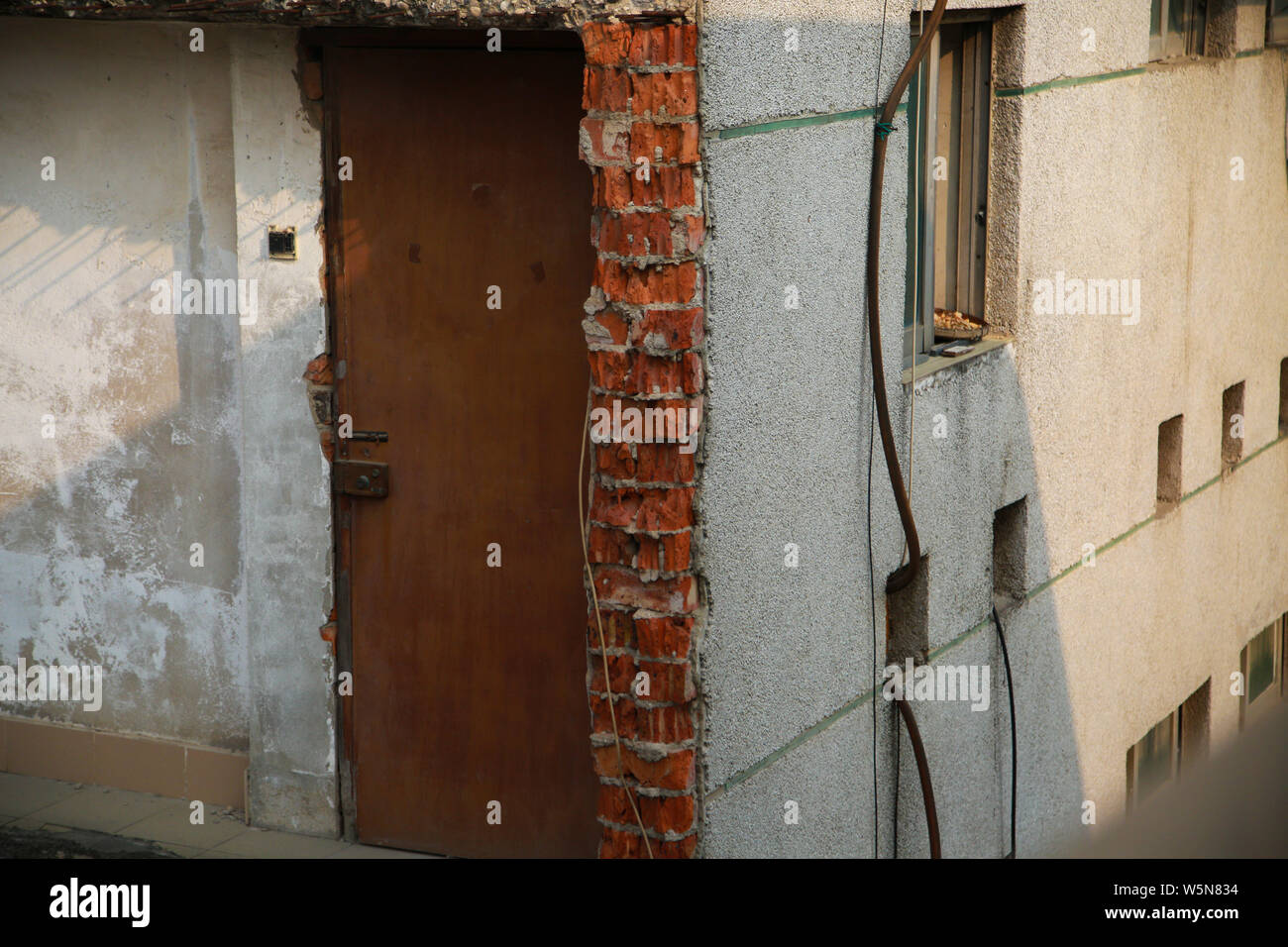 The half-demolished nine-floor residential building is pictured in ...