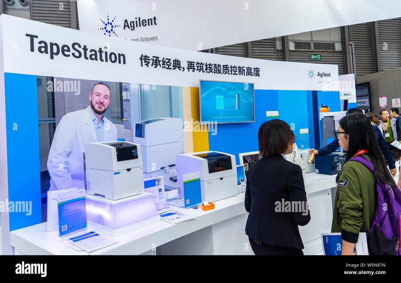 People visit the stand of Agilent TapeStation during an exhibition in ...