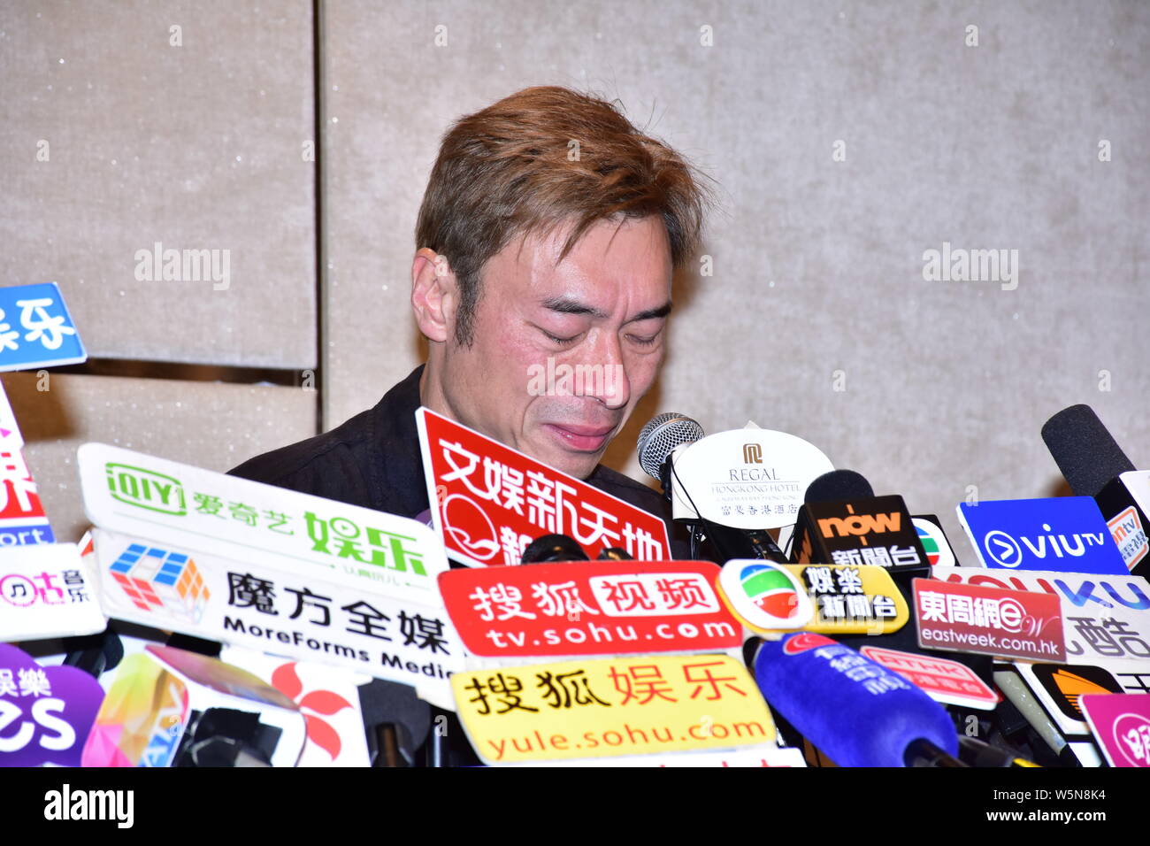 Hong Kong singer Andy Hui or Hui Chi-on speaks and weeps during a press ...