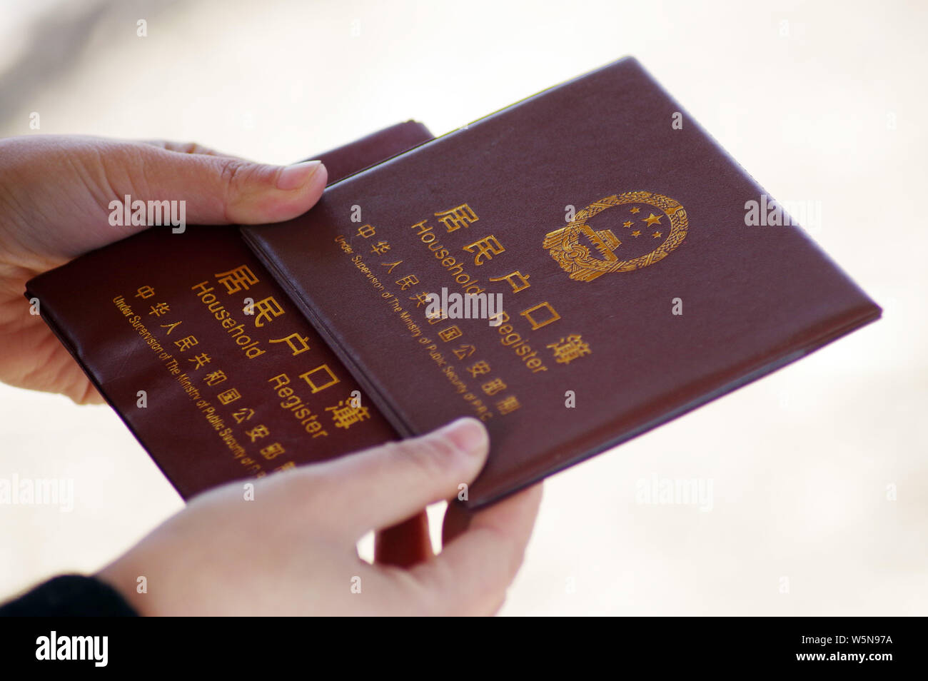 --FILE--A local Chinese resident shows his household registers, also ...