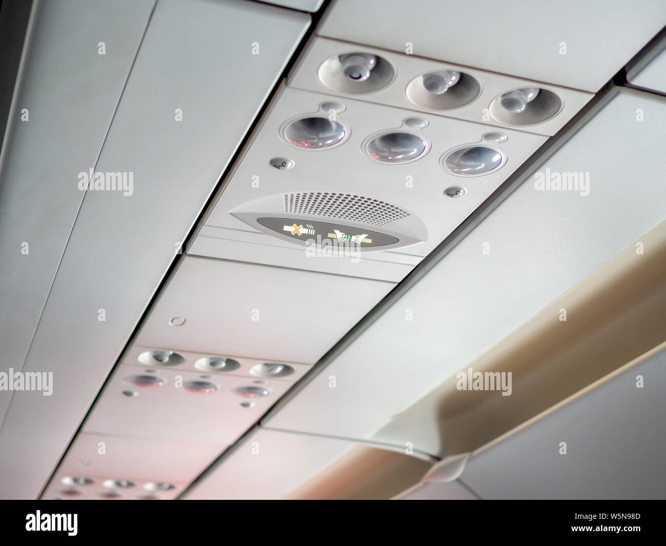 Control panel overhead and icons in economy class cabin in airplane for ...