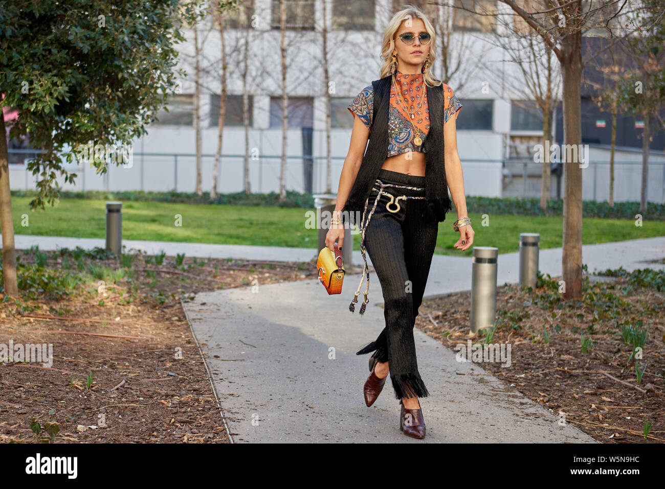 A trendy woman poses for street snaps during the Paris Fashion Week ...