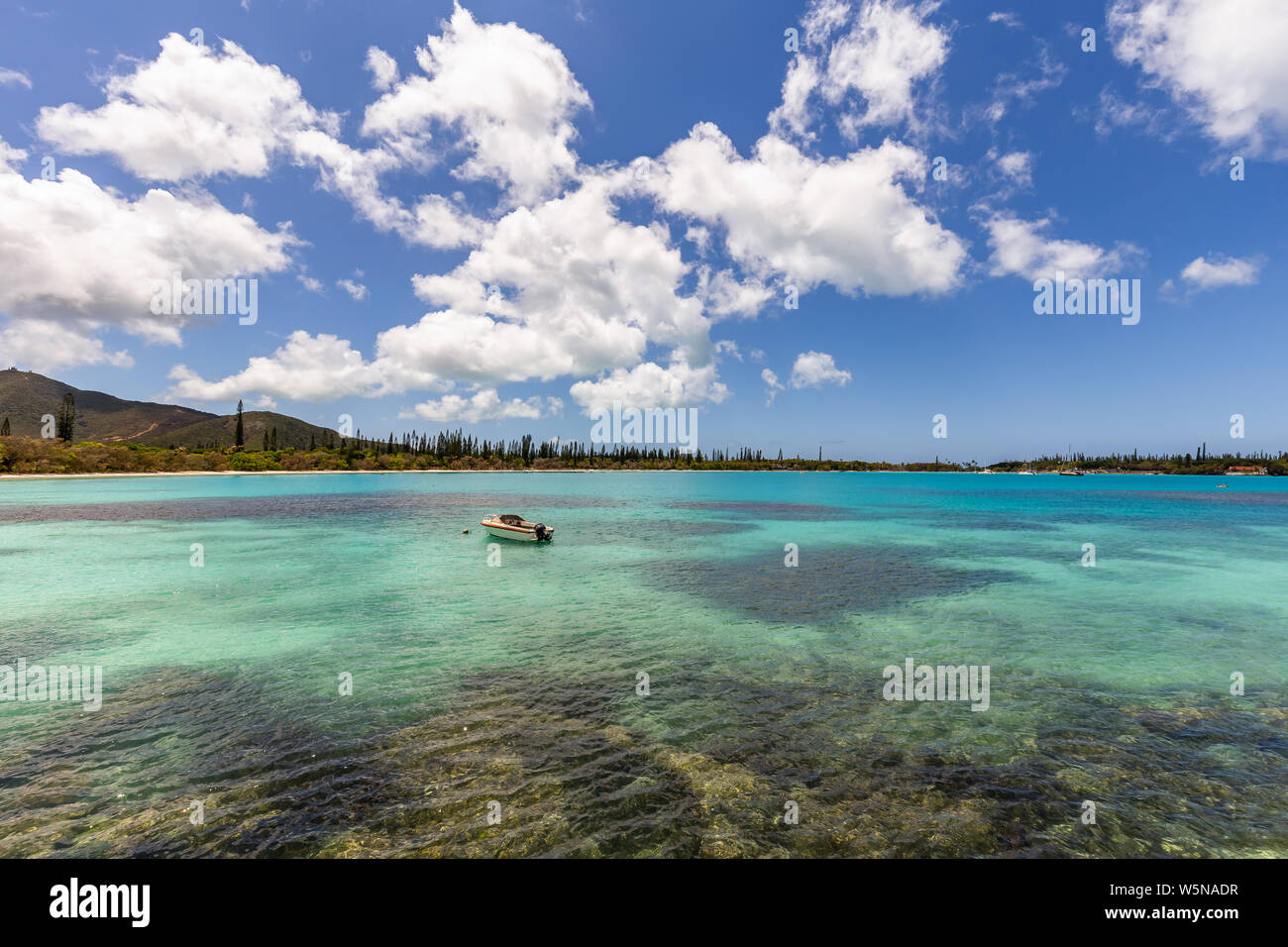 Fishing boat sailing next to a tropical island Stock Photo - Alamy