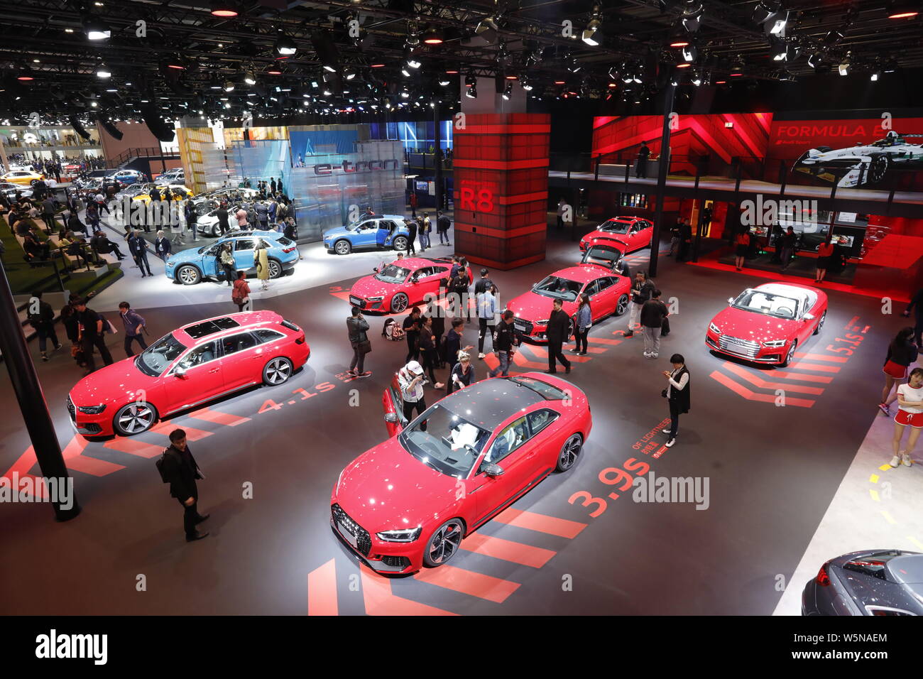 People visit the stand of Audi during the 18th Shanghai International ...