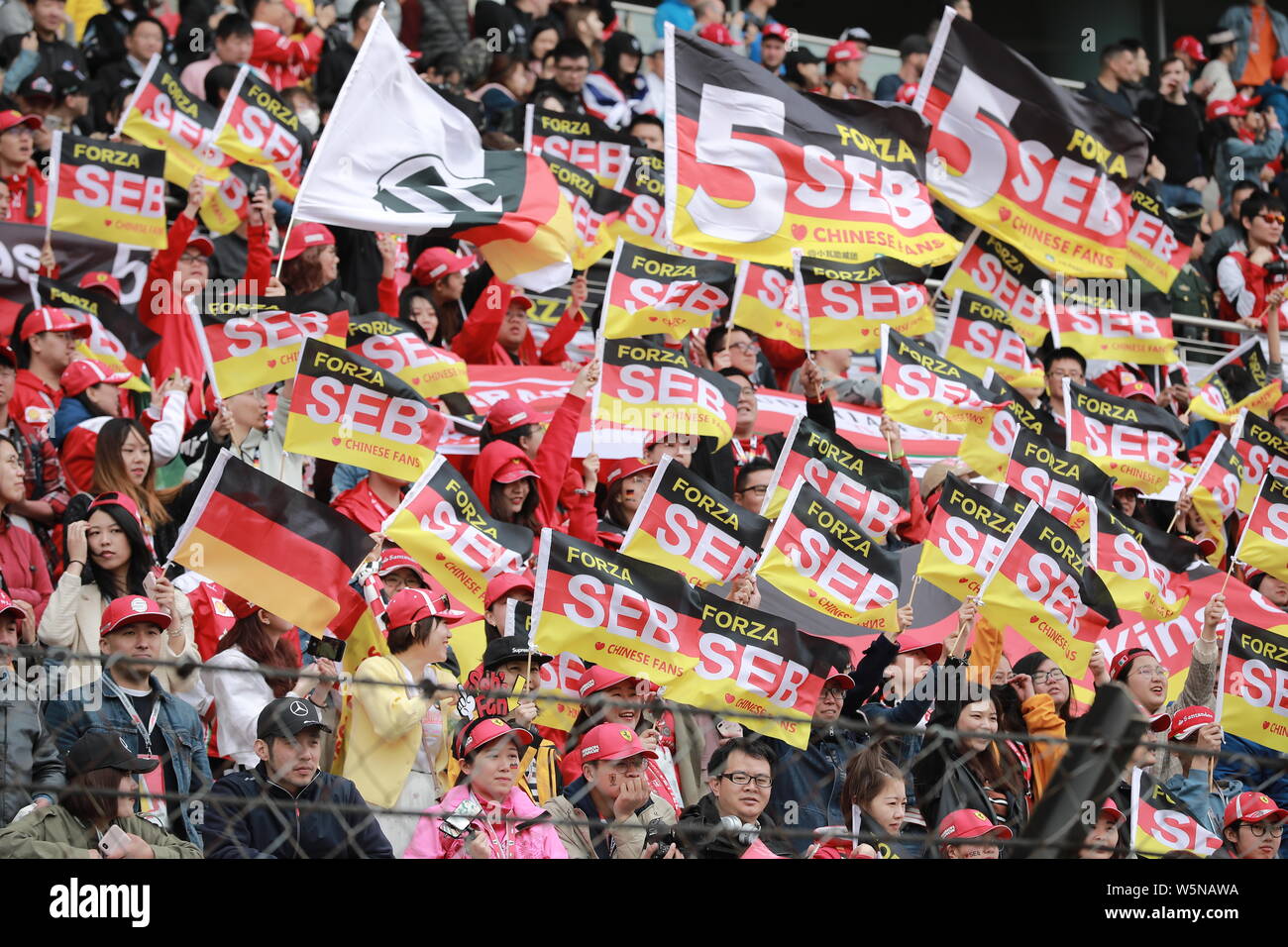Fans cheer for German Formula One driver Sebastian Vettel of Ferrari ...