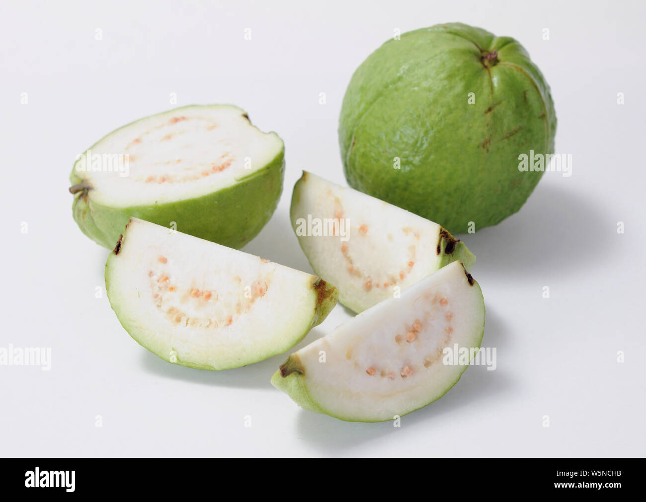 chopped and full green guava (delicious tropical fruit) isolated on ...