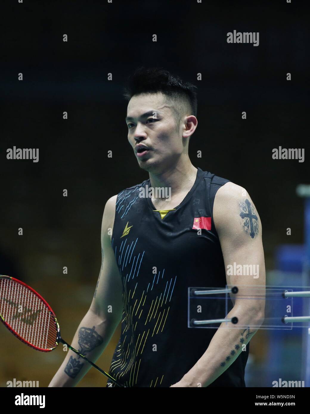 Lin Dan of China reacts while competing against Lu Chia-hung of Chinese Taipei in their first ...