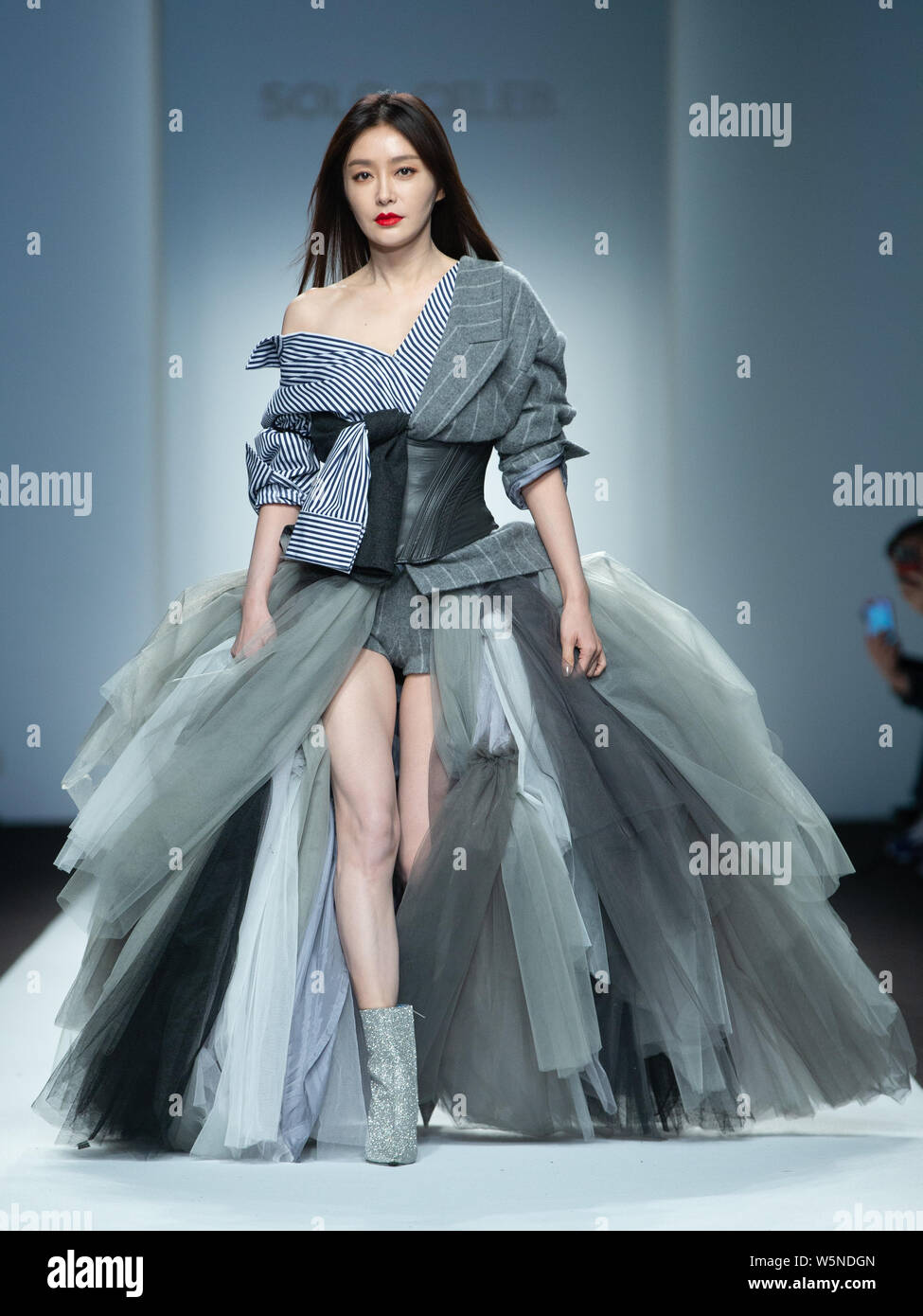 Chinese singer and actress Qin Lan displays a new creation at the Solo Celeb show during the ...
